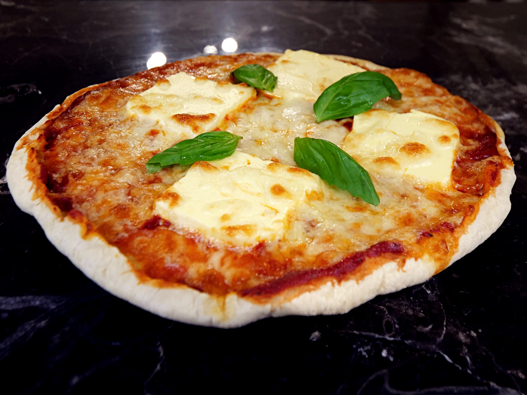 Pizza with mozzarella and tomato sauce